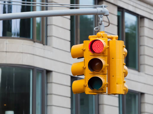 How does going through a red light affect liability for accidents in ...